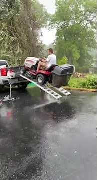 Man and Lawn Mower Fall as Ramp Slips Off - 1510358