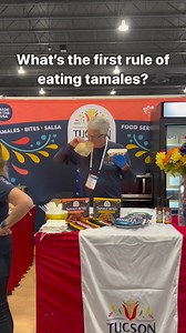 What's the first rule of tamale eating? 🤔 Traveling coast to coast to share our amazing tamales, we see a lot of first-timers make the common mistake of trying to bite into the husk. That’s why we put 'Don’t Eat the Husk' on our show shirts—consider it a helpful hint from us to you! 🤭 #TamaleTips #Don’tEatTheHusk #TamaleAdventures | Tucson Tamale Company