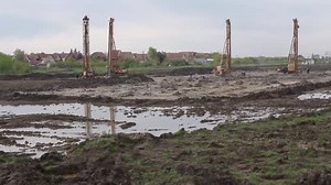 Pile driving machine in construction site.