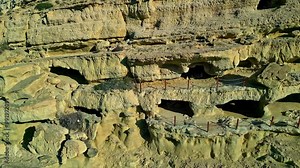 Close-Up View Of Limestone Caves Of Matala Near The Beach In Crete, Greece. aerial, sideway shot