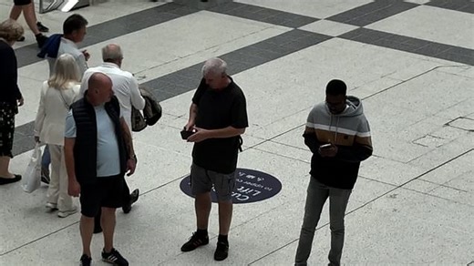 Commuters at Liverpool Street station react to national emergency alert system