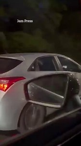 Moment brazen woman caught watching TV on her phone while driving | The Sun