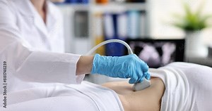 Doctor moving ultrasound probe on belly of pregnant woman. Abdominal pain and diagnosis of early pregnancy concept