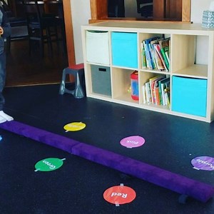Balance beam challenge! . Use a ball and bounce it on the color that is called out! . Try this side stepping along the beam as well. . The color spots can be found in the Pink Oatmeal freebie library. . Link in profile. https://www.pinkoatmeal.com/freebie-library . ☝️Follow Pink Oatmeal for more ideas and resources. | Physical Activity & Motor Development for Kids by Pink Oatmeal