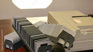 antique white slide projector seen from the side, from above with the slides scattered, the light of the proiector projected on the white wall,