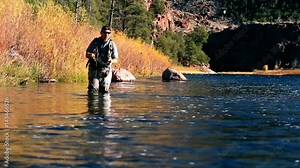 Man in river casting fly rod upstream