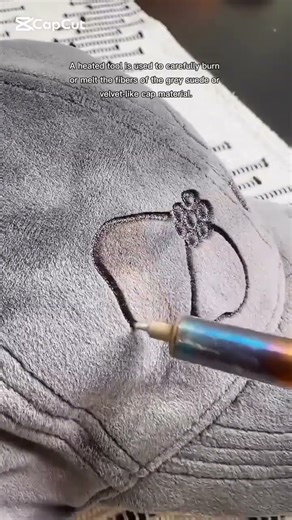 creates a dark, permanent, and slightly recessed design on cap