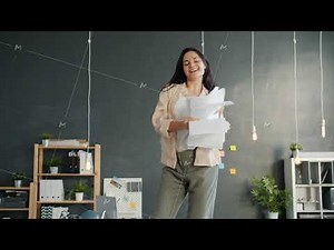 Happy office worker dancing on table throwing papers enjoying music and freedom