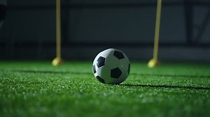 clip-1099123301-kicking-football-ball-closeup-slow-motion-player