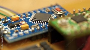 Electronics repair. Microcircuit with electronic components connected to power supply. Small electronic circuit with burning red LED light bulb. Microcircuit, resistors and chips. Stepper motor driver