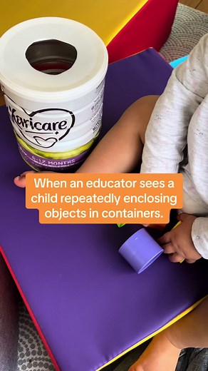 When a child repetitively puts objects into a box, it often indicates an