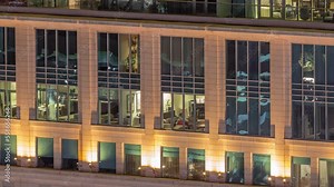 Windows of apartment buildings at night timelapse, the light from the windows of houses. Evening landscape of the city with glowing illumination