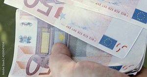 Close view counting banknotes with first person camera. Counting money. Pass euro bills one by one. hands counting euro banknotes. Holding banknotes with hands. Top view of paper money. vertical video