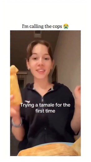 og memer on Instagram: "The video features a young woman who is trying a tamale for the first time. Introduction: She holds up the tamale, which is wrapped in a corn husk, and mentions that her Mexican friend told her they are very good, expressing her excitement. The Mistake: She takes a huge bite directly out of the tamale, corn husk and all. Her initial reaction is a confused/pained expression because the husk is not meant to be eaten. The Realization: After chewing briefly, she pulls the tam