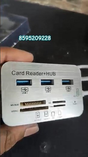"Card Reader+HUB device in its packaging.The device is silver with multiple slots for memory cards.