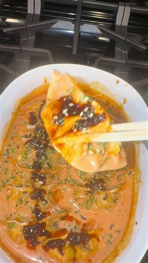 Nah it’s cold outside FR FR so hop in the kitchen and make you something that’s gonna warm your stomach up ! 🥶 Ingredients • 1 can coconut milk, • 2 tbs red curry paste, • 2 cloves garlic, minced • ¼ cup soy sauce (optional) I didn’t use cause I like spice • Scallions • dumplings, frozen • chilli crunch, • Furikake combine coconut milk, red curry paste, minced garlic, and soy sauce. Whisk until well combined to create the sauce. Add the frozen dumplings of your choice to an oven-safe dish or ba