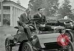 1933 – Dearborn Michigan USA: Henry Ford with Edsel Bryant Ford pose in several old Ford cars at Greenfield Village, Michigan.