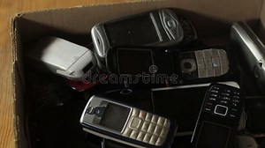 Outdated Cell Phones are in a Big Pile in a Cardboard Box. Stock Footage - Video of button, black: 178751708
