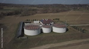 Flying over a sewage treatment plant from a bird's eye view. The sewage treatment plant is equipped with solar panels to obtain ecological energy for the operation of the filters.