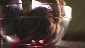 Chef handling boiled beets in a glass bowl during food preparation