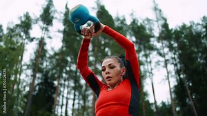 Attractive Sportswoman Training With Weights In Nature, Strong Lady Lifting Kettlebell, Portrait