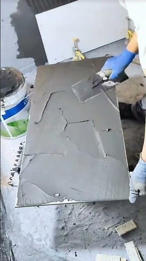 the process of installing rectangular white ceramic tiles on the walls of a building #construction