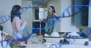 Two women pulling sweaters from open suitcase and placing dress inside, packing luggage for travel