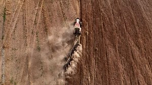 Tractor with disc cultivator on land cultivating. Disk harrow on plowing field. Soil cultivation field use tractor. Tractor disk harrow on field cultivation. Cultivated land and soil tillage.