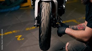 close up In a motorbike repair shop suspension system for a motorbike is repairing the front wheel