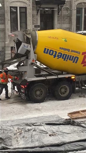 Working hard or barely working. Sidewalk construction in Montreal.