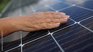 Close up of young engineer hand is checking the operation of sun and cleanliness of photovoltaic solar panels. Concept.renewable energy, technology, electricity, service, green, future.