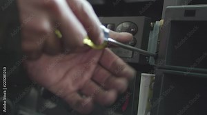 mechanic installing radio inside a car