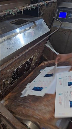 The process of embossing paper in a printing press.