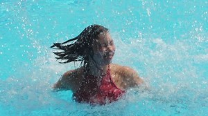 clip-30617482-woman-relaxing-swimming-pool-under-waterfall-slow