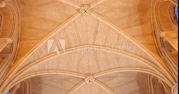 Warm interior view of the vaulted ceiling inside Southwark Cathedral showing gothic architectural details.