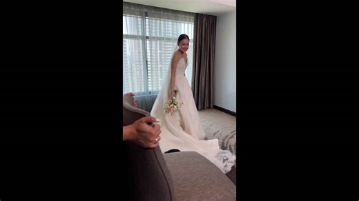 Loving pet dog curls up and sleeps on bride's wedding dress