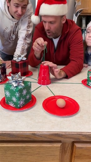 the Present String Pull Game 🎁 PART 2 Kids, Dad, and family play festive table game with presents and strings. Funny Christmas gift game for family gatherings or Holiday parties. (for entertainment purposes only) " 🎬 This video was produced by Network Media and Benson Bros" | Play Together Stay Together