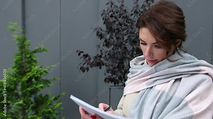 Young business woman sign in documents outside. Office worker, female director checks papers walking outdoor. Madam stands and works with the document. Lady signing contract outdoors