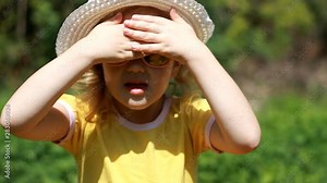 Child smearing his fase and body sun cream Sunburn. Suncream cream. Sunprotection cream. Closeup baby girl.