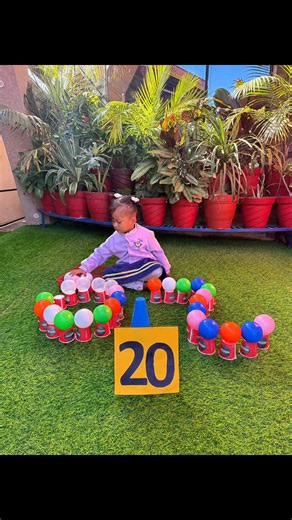 This playful math activity helped children understand the number 20 in a concrete way. With each ball placed carefully on a cup, they practiced counting, number identification, and patience — all while enjoying the learning process. #LearningThroughPlay #Number20 #CountingTo20 #HandsOnLearning #KidzzHeavenMontessoriSchool | Kidzz Heaven Montessori School