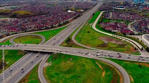 Aerial view of freeway intersection. Clip. Highway and overpass with cars and trucks, interchange, two-level road junction in big city. Top view traffic concept freeway interchange carry heavy traffic