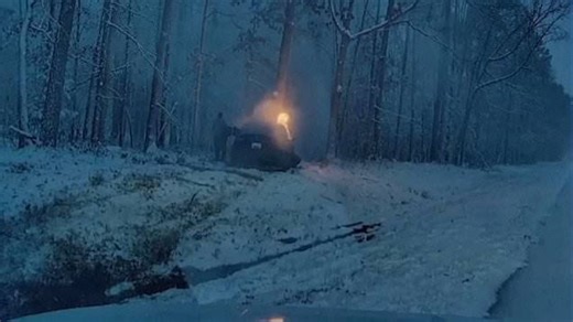 Dashcam footage captures moment police officer rescues man from burning Tesla