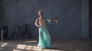 slow motion happy ballet dancer makes pirouettes in the rays of light