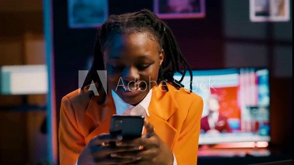 College student doing her homework at laptop and texting on phone, enjoying school break to check social media apps. Girl researching for assignments and using smartphone. Camera A.