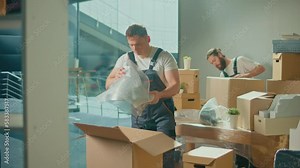 Workers of Moving Company With Uniforms Carefully Packing and Carrying Boxes. Shipping and Packaging Business Occupation Service Company. Preparation for a Long Trip, Transportation of Things