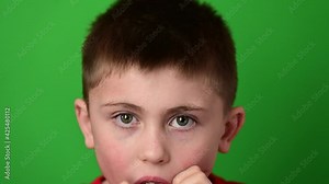 The boy on a green background puts on a plate for alignment of front upper teeth, alignment of upper teeth.