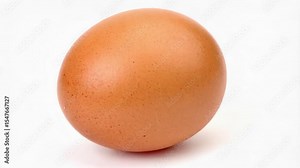Isolated brown chicken egg against a plain white background in a studio setting showing the subtle texture and color variations of the eggshell.