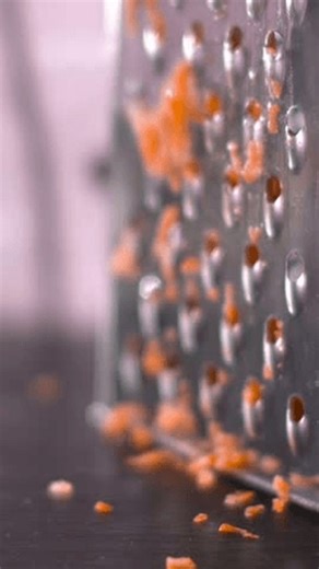 clip-3994760657-grating-cheese-kitchen-setting-metal-grater-fresh