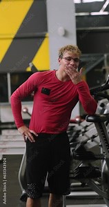 portrait Muscular young man at sport gym, confident bodybuilder working out with weights in sport club, bodybuilding concept , with exercise equipment and dumbbells, vertical footage