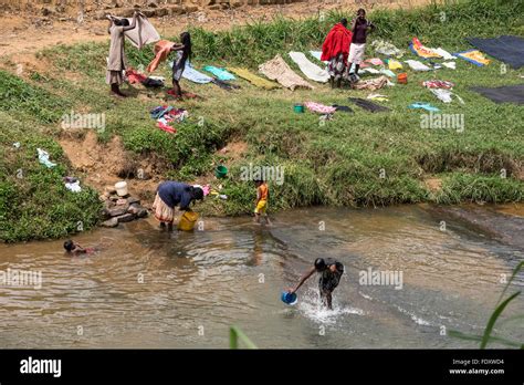 Local Women Bathing And Washing In A River Near Their Village In The